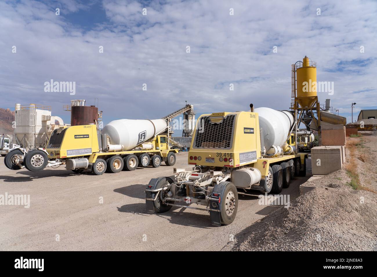 Two cement trucks or agitating mixer or transit mixer trucks at a ...