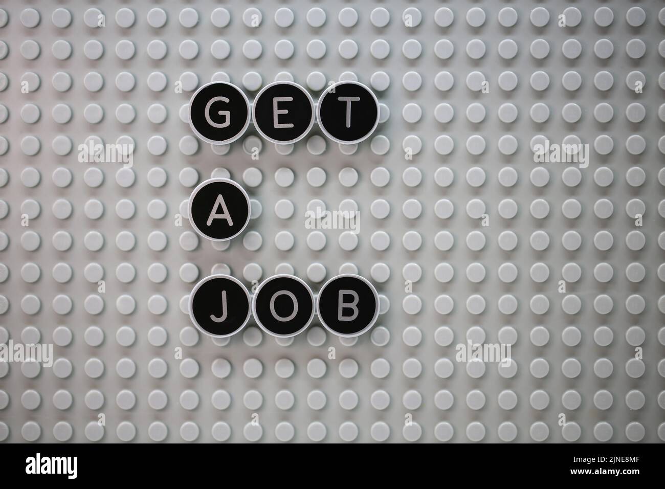 Get a job word puzzle on the lego plate Stock Photo - Alamy