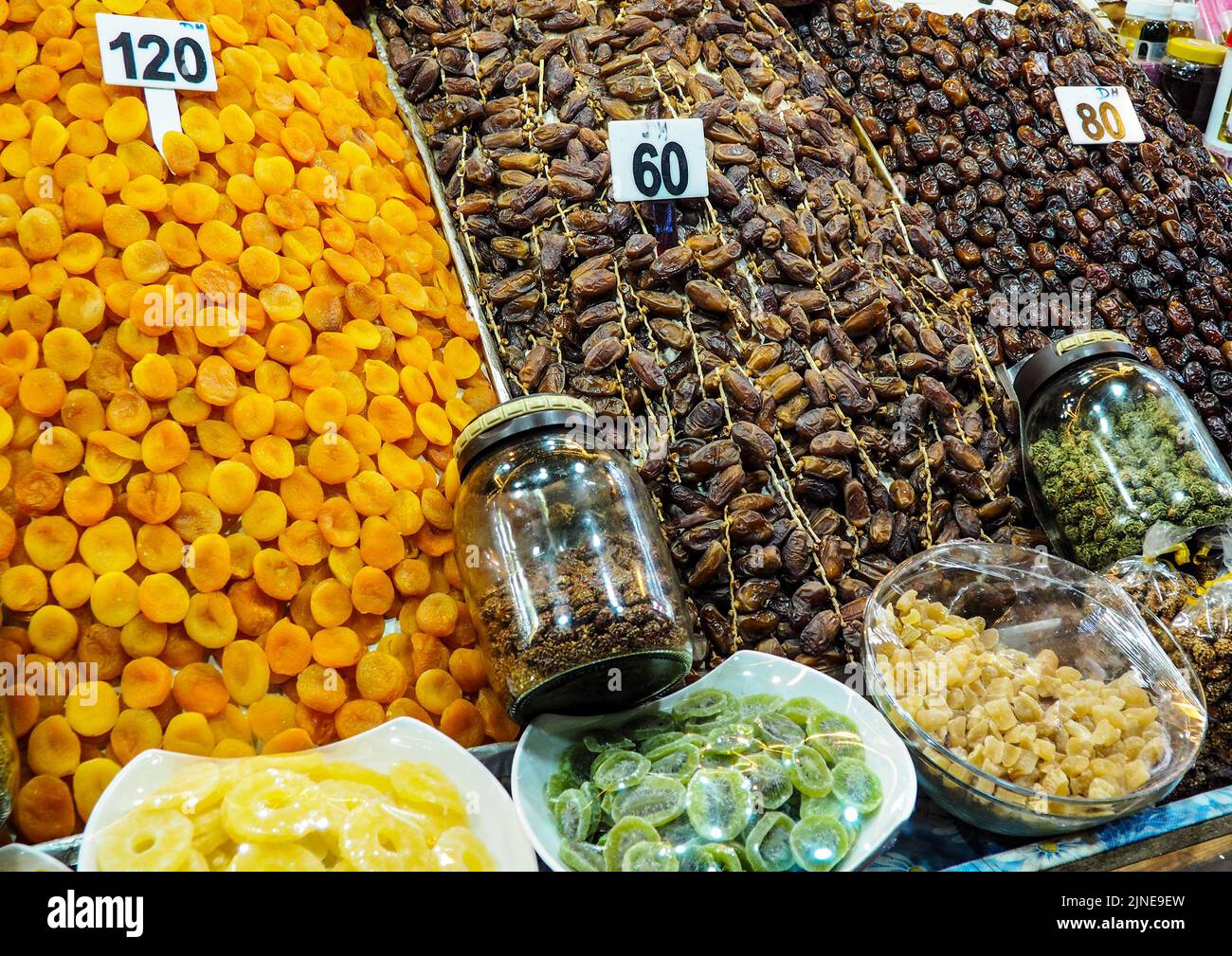 Dried candied fruit and sweet dates on display at street market in ...