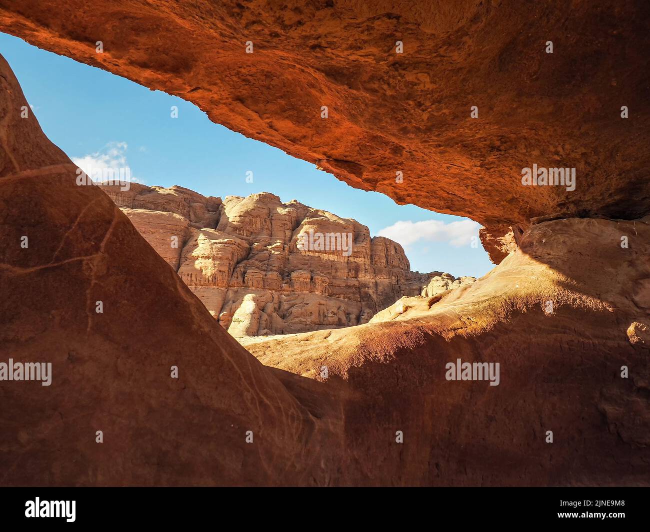 Little arc or small rock window formation in Wadi Rum desert, bright ...