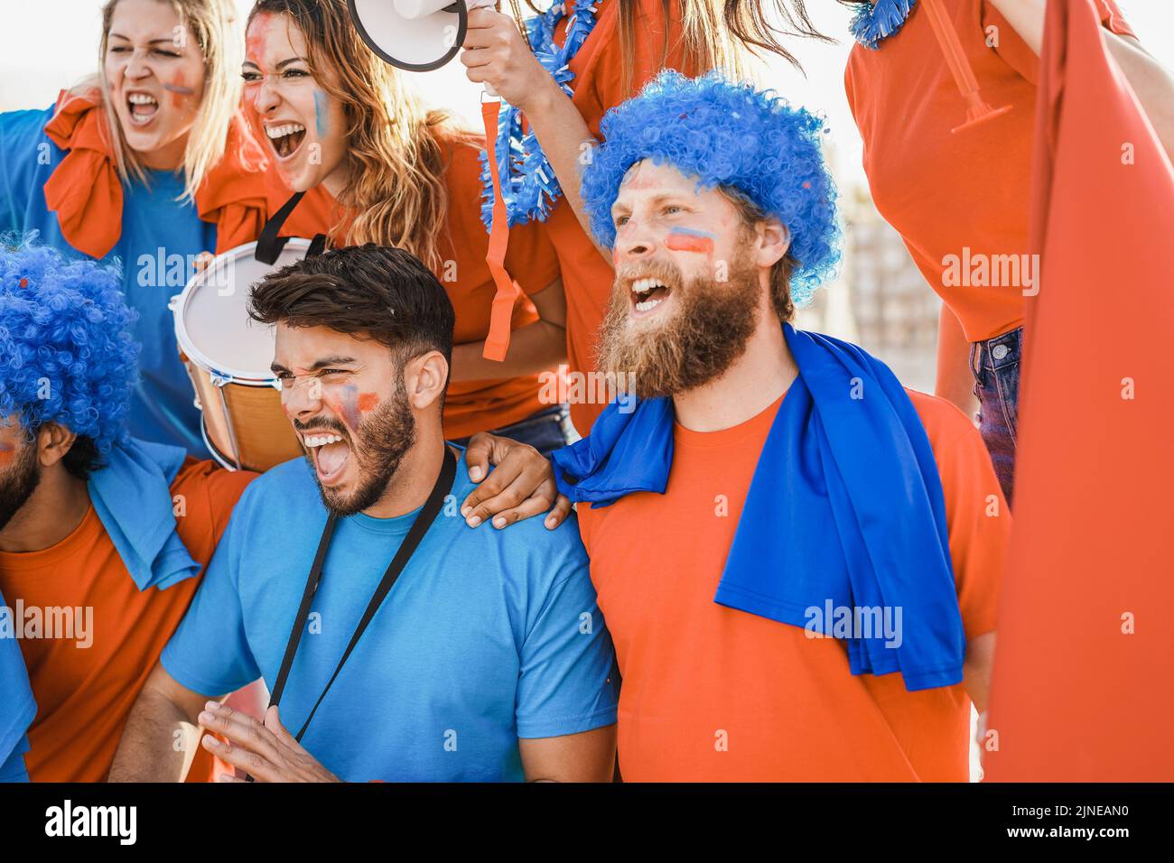 Crazy sport fans screaming while supporting their team - Focus on left ...