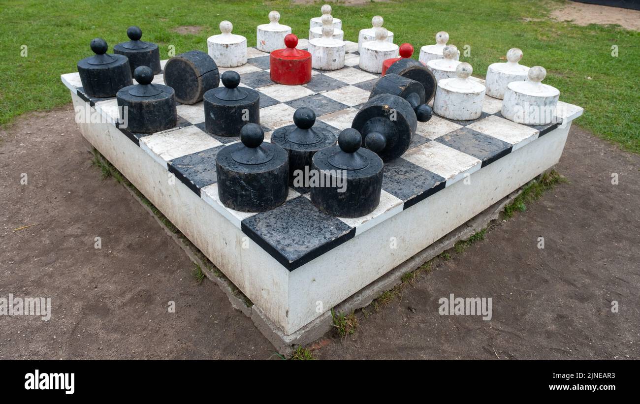 A large checkerboard with dice. Black and white playing fields. In a ...
