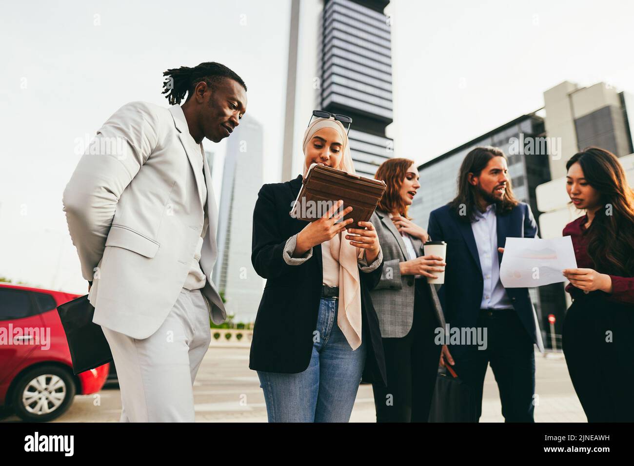 Multiracial business people working outdoor from office building ...