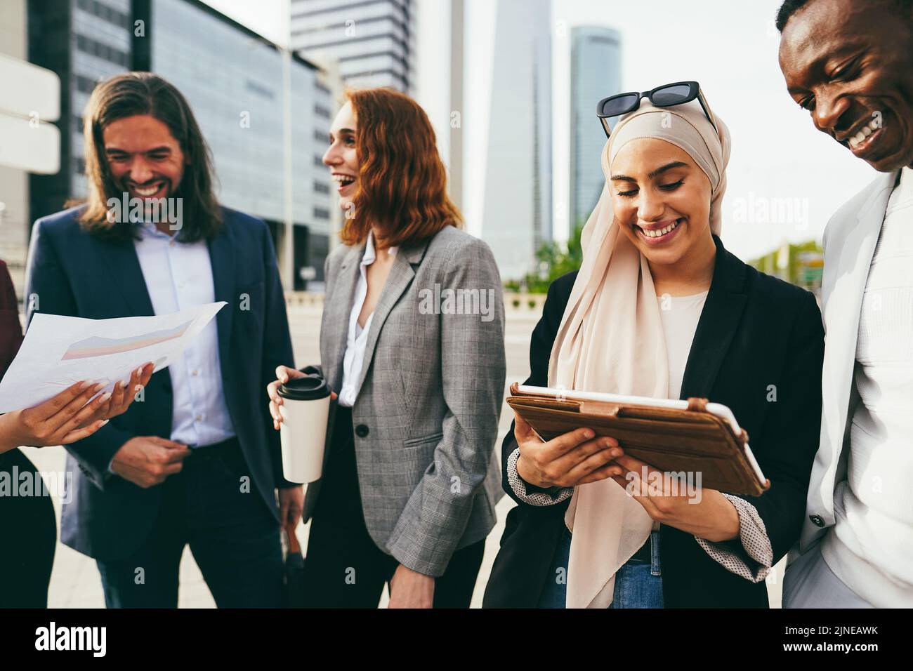 Multiracial business people working outdoor from office building ...