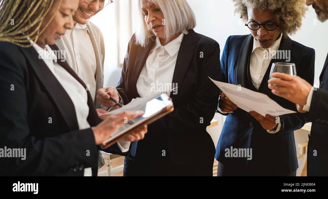 Multiracial business people working inside bank office - Focus on right ...