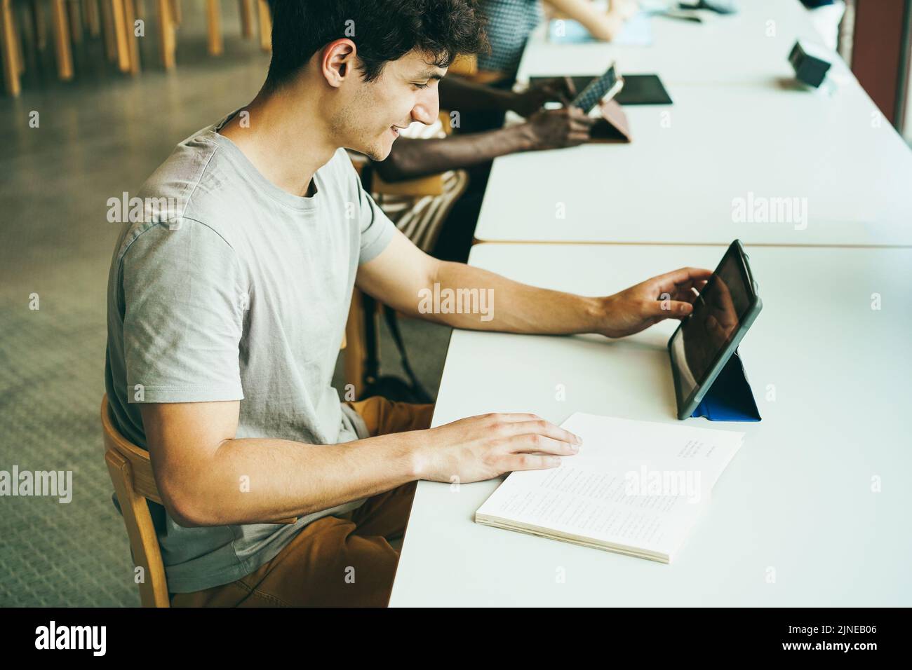 Multiracial students doing research for project inside university ...