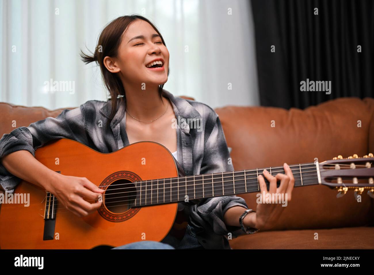 Talented and attractive young Asian female sings her favourite song ...