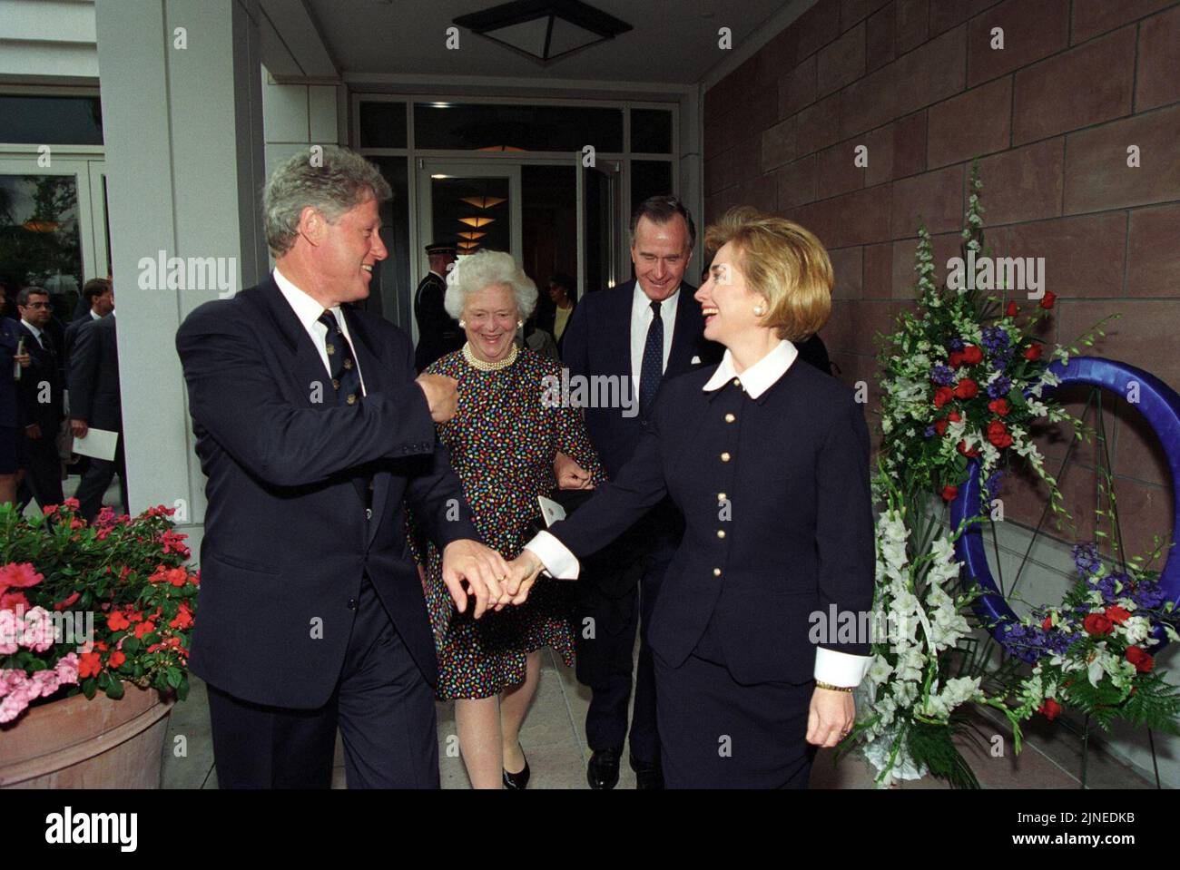 The Clintons walking with President George H. W. Bush and Barbara Bush ...