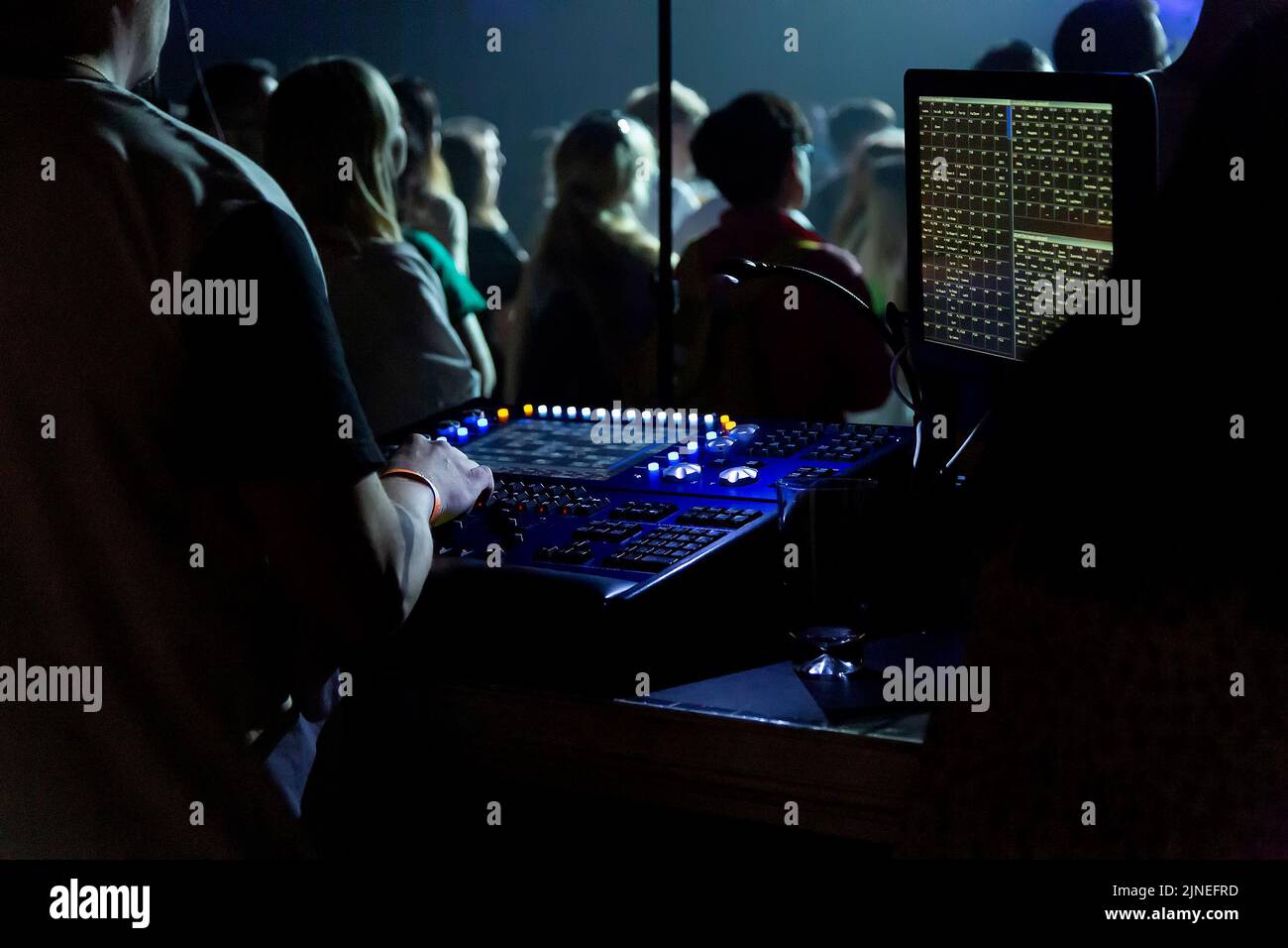Soundman working on the mixing console in concert hall Stock Photo - Alamy