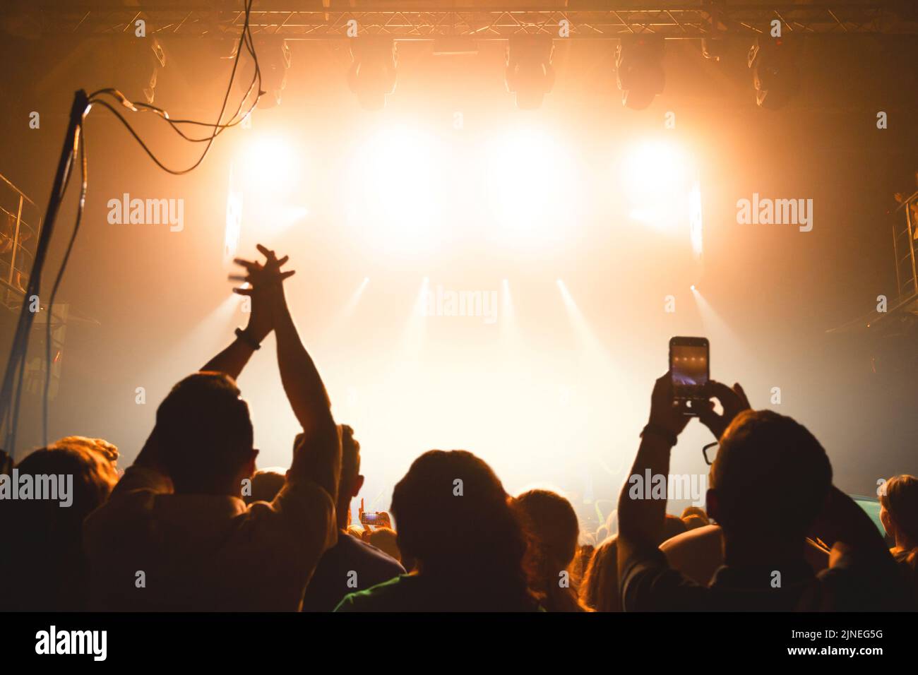 The audience applauded by the stage artist. They shines the spotlight ...