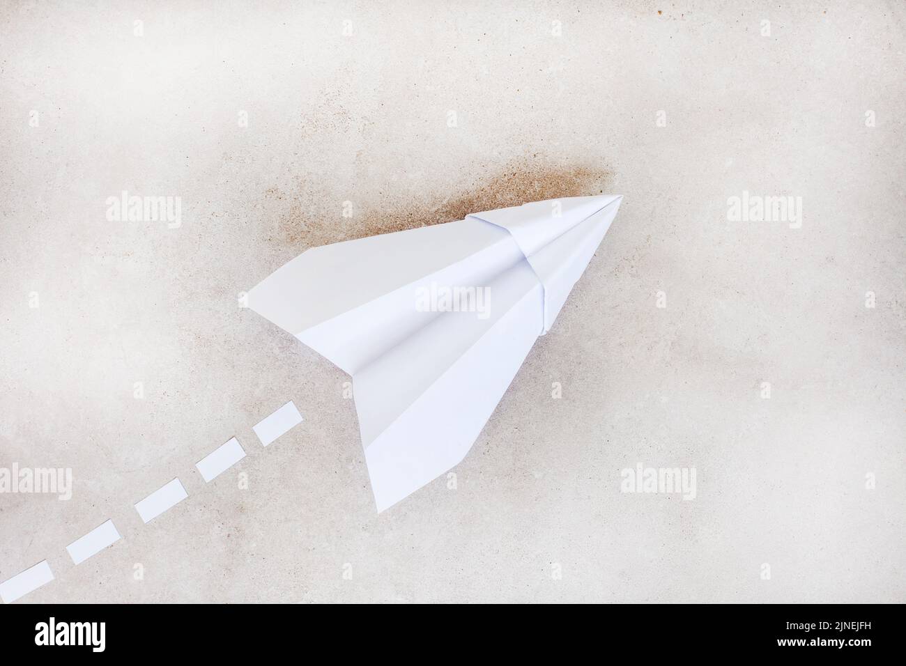paper airplane as metaphor, taking off and rising, on grey with copy ...