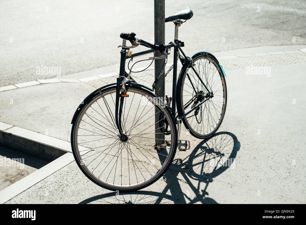 Bicycle leaning against pole hi-res stock photography and images - Alamy