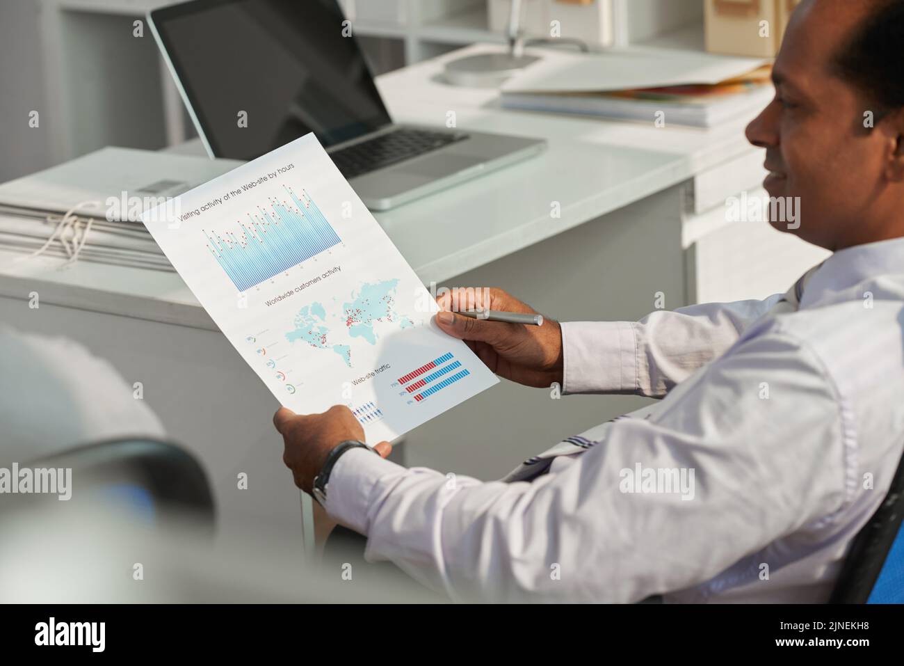 Indian businessman happy with good financial report Stock Photo - Alamy