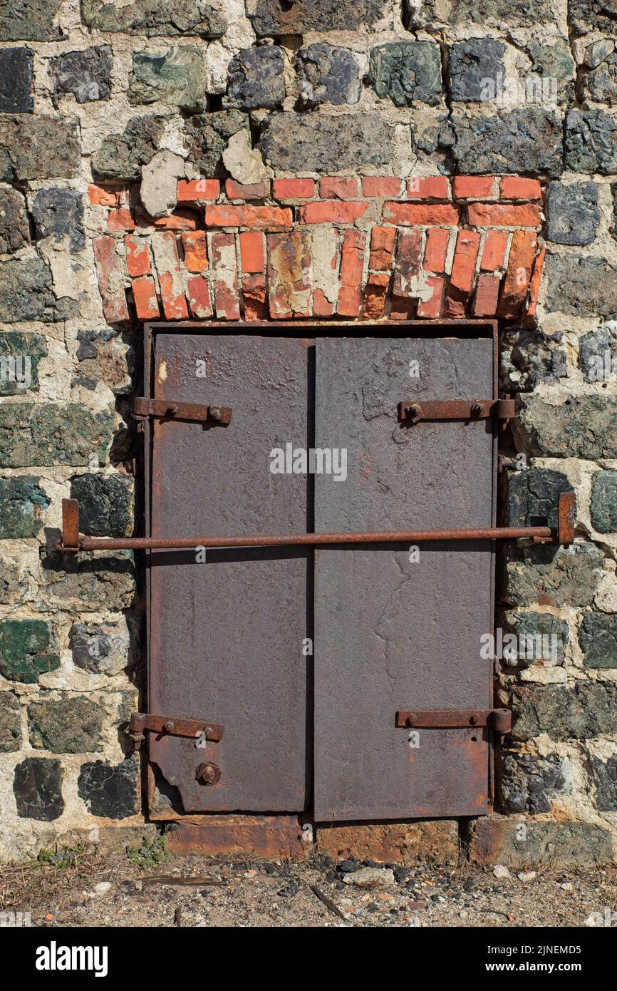 Rusty metal doors on old brick building Stock Photo - Alamy
