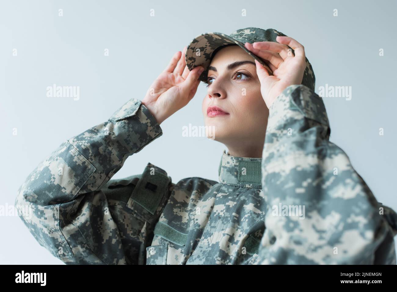Soldier in military uniform wearing cap isolated on grey,stock image ...