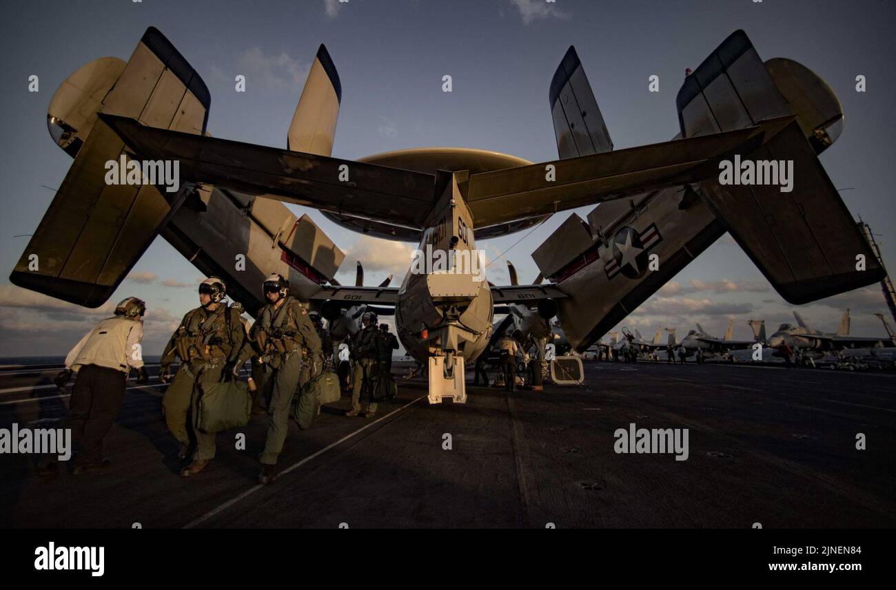 The crew of an E-2C Hawkeye depart the aircraft via the flight deck of ...