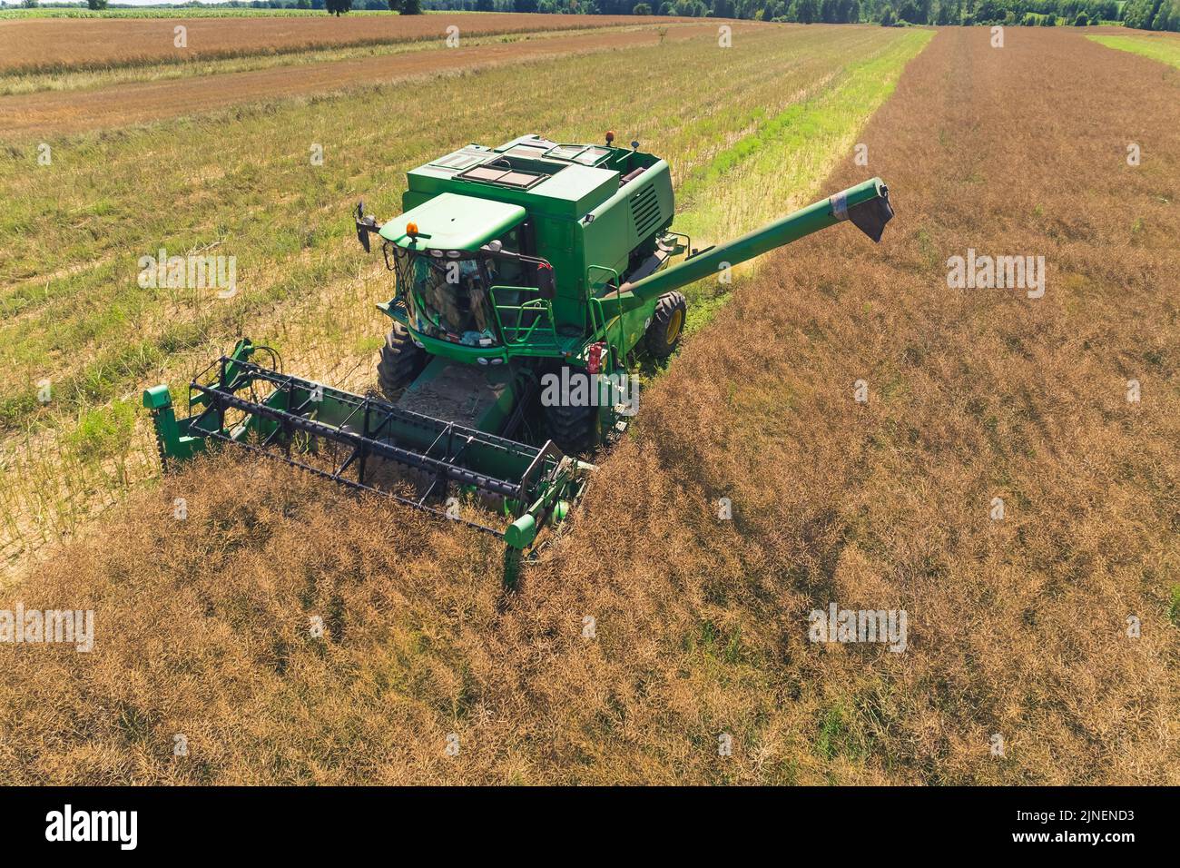 Aerial view of a green agricultural combine with a revolving reel ...