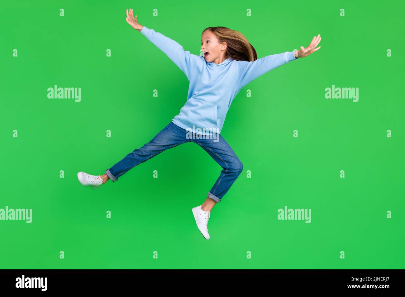 Full size photo of active little girl jump spread hands wings have fun ...