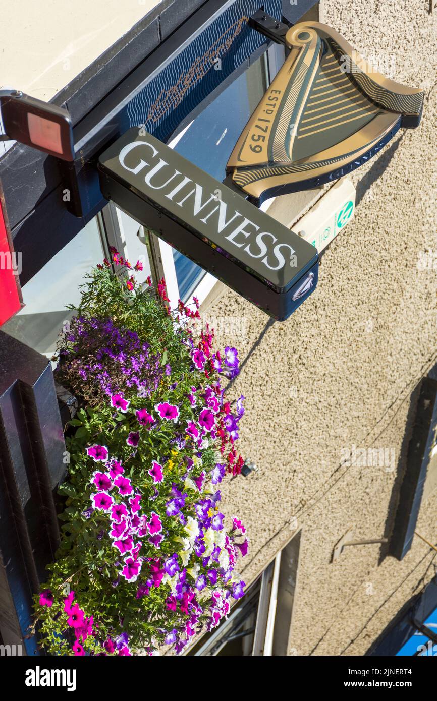 Pub or bar exterior with flowers and Guinness sign, Donegal Town ...