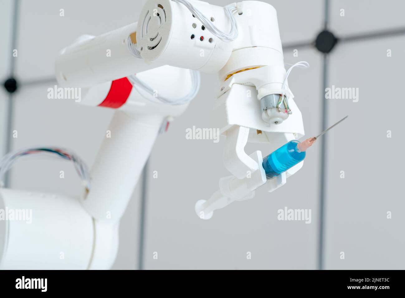 Robot hand with a medical syringe. Future medicine concept using robots ...