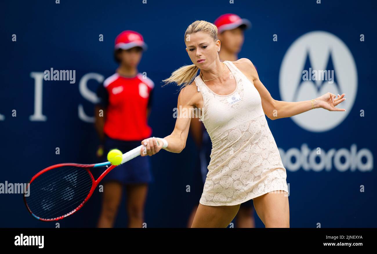 Camila Giorgi of Italy in action against Emma Raducanu of Great Britain ...