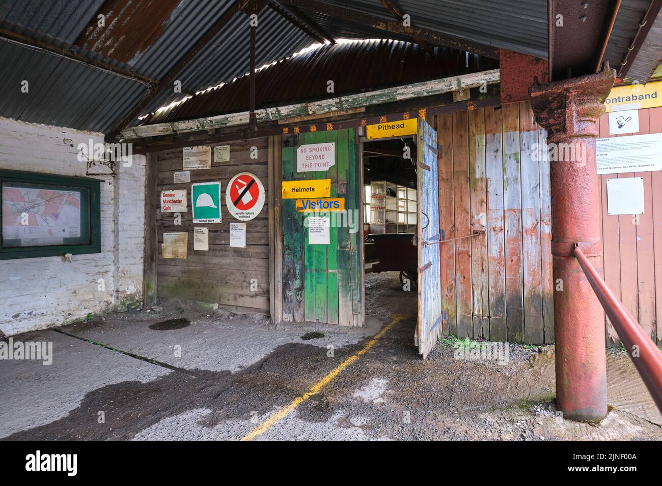 Old wooden doors with various identification, warning signs before ...