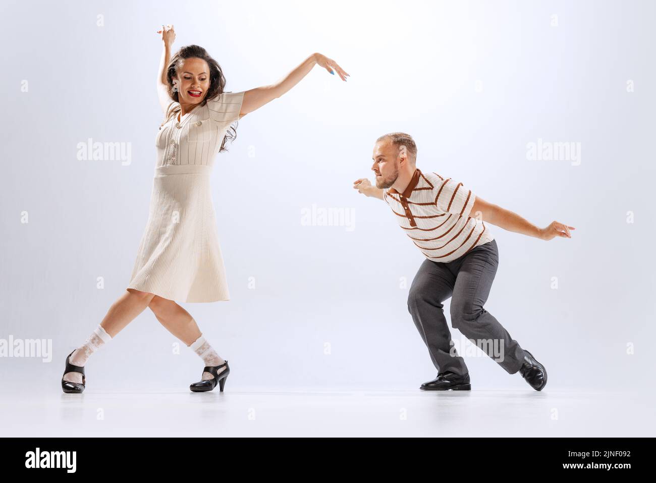 Rhythm and expression. Energetic dance couple in retro style outfits ...