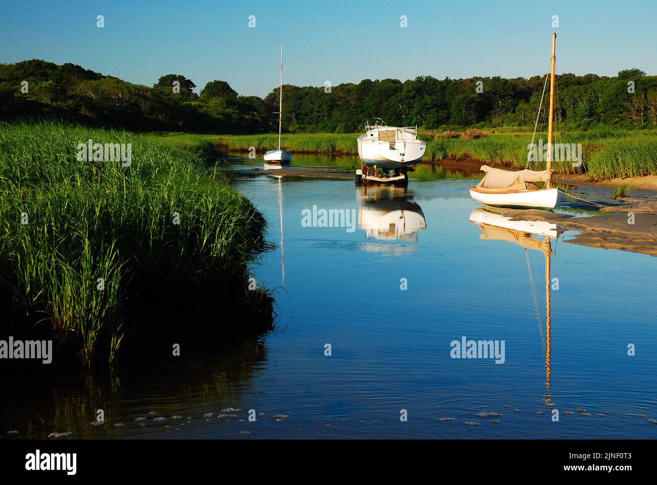Boats moored at Brewster Creek Park, in Cape Cod, stand above the water ...