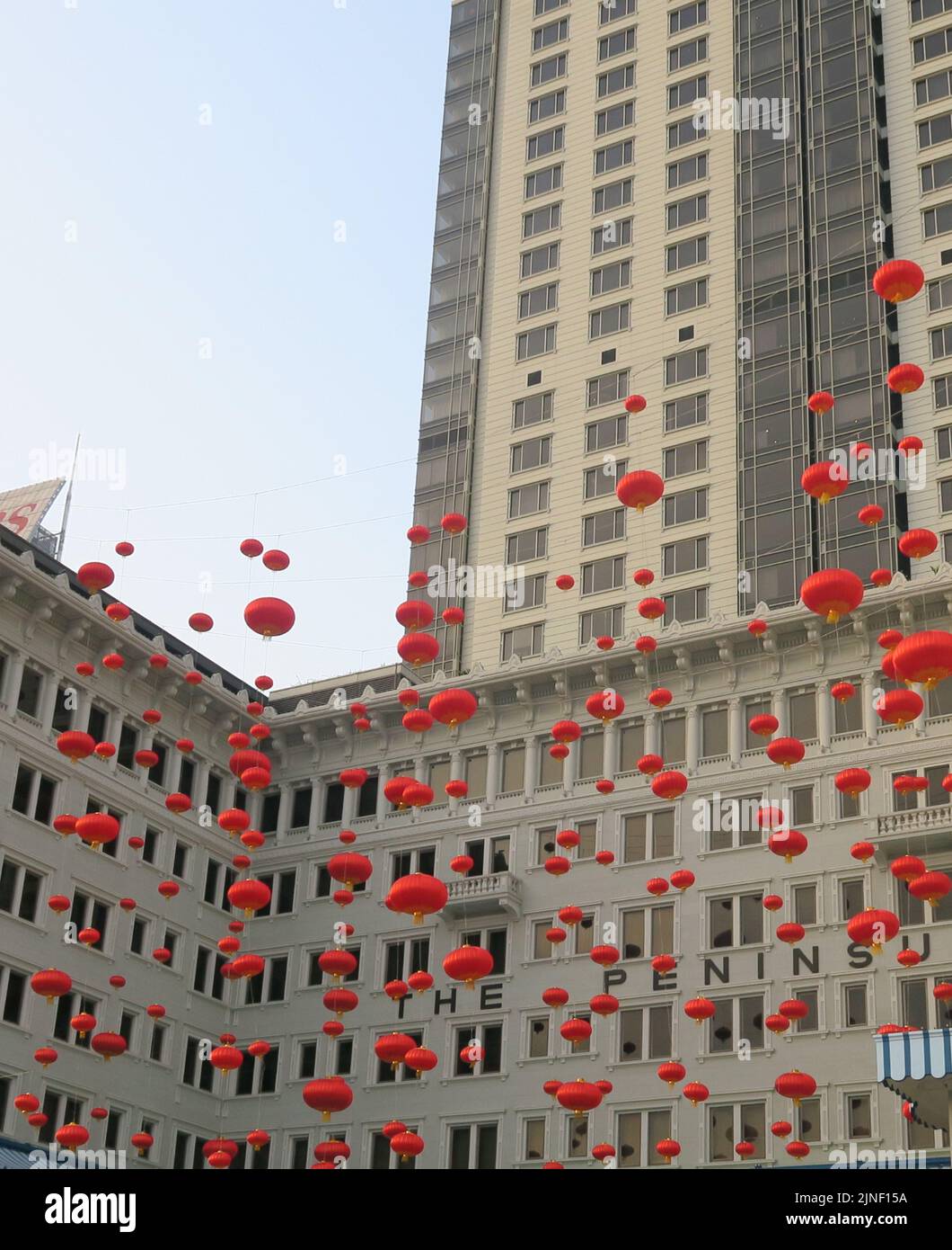 A red Chinese New Year lanterns in front of a tall building in Kowloon ...