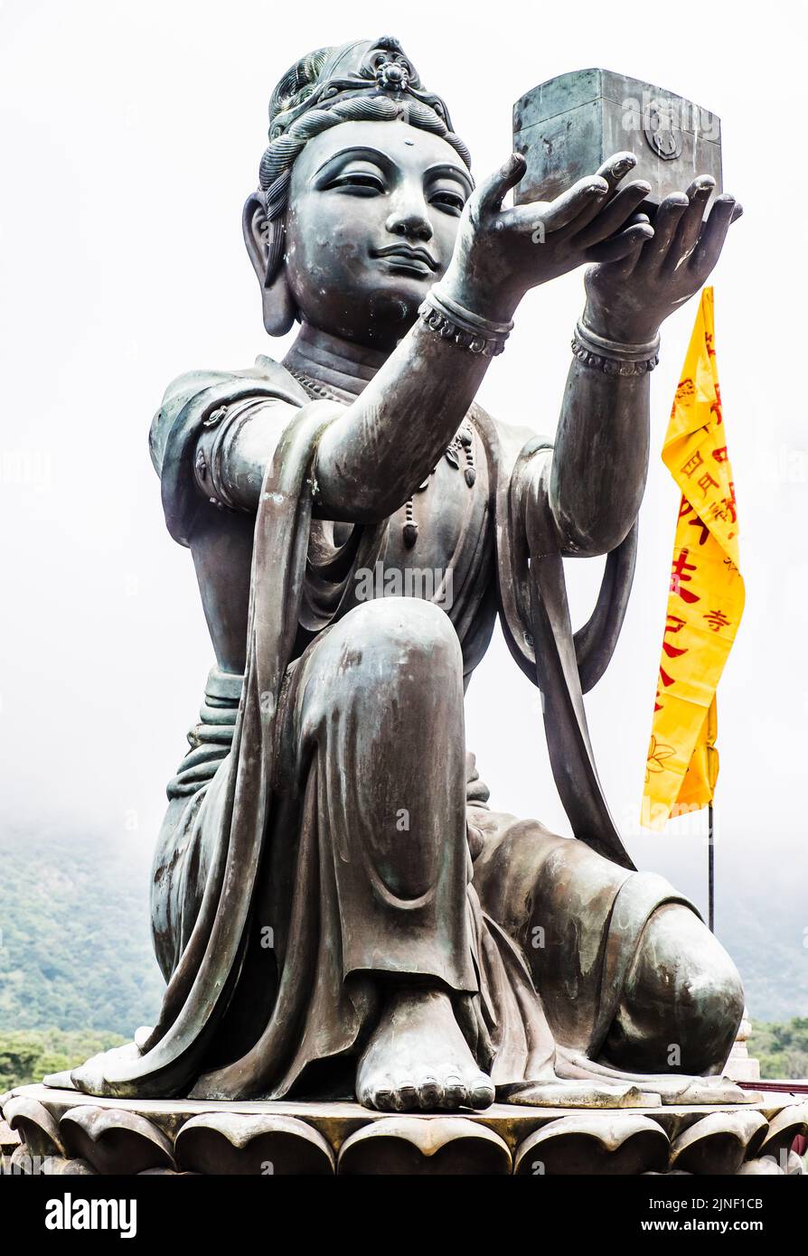 A statue of the Goddess making an offering to the Tian Tan Buddha Stock ...