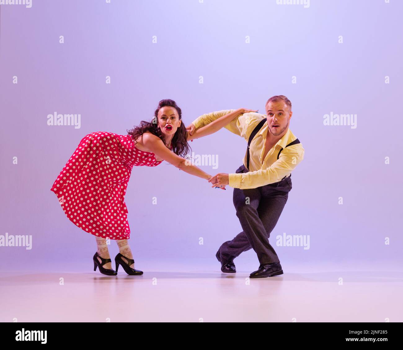 Emotional bright couple of dancers in colorful retro style attires ...