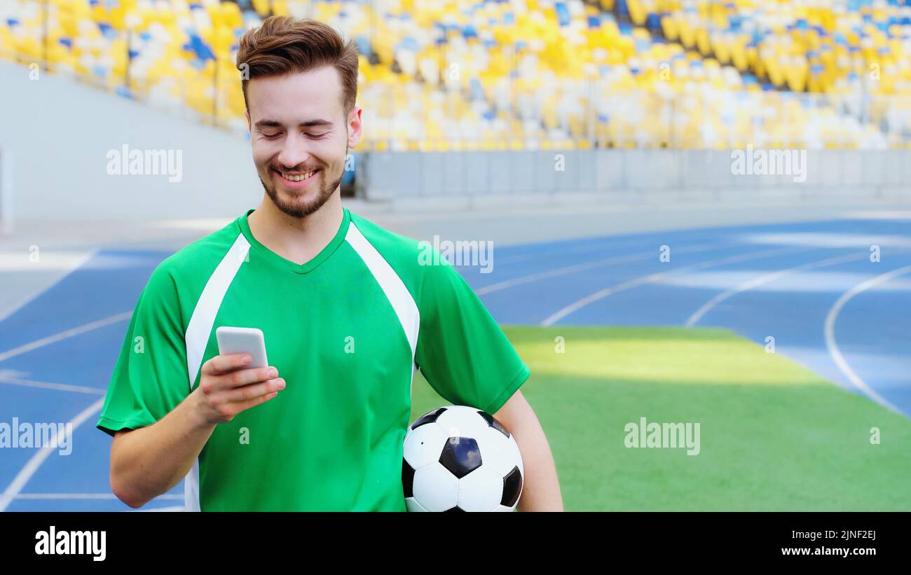 Mobile phone football shirt hi-res stock photography and images - Alamy