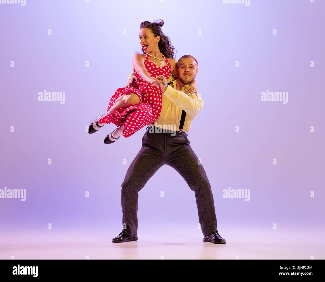 Emotional bright couple of dancers in colorful retro style attires ...