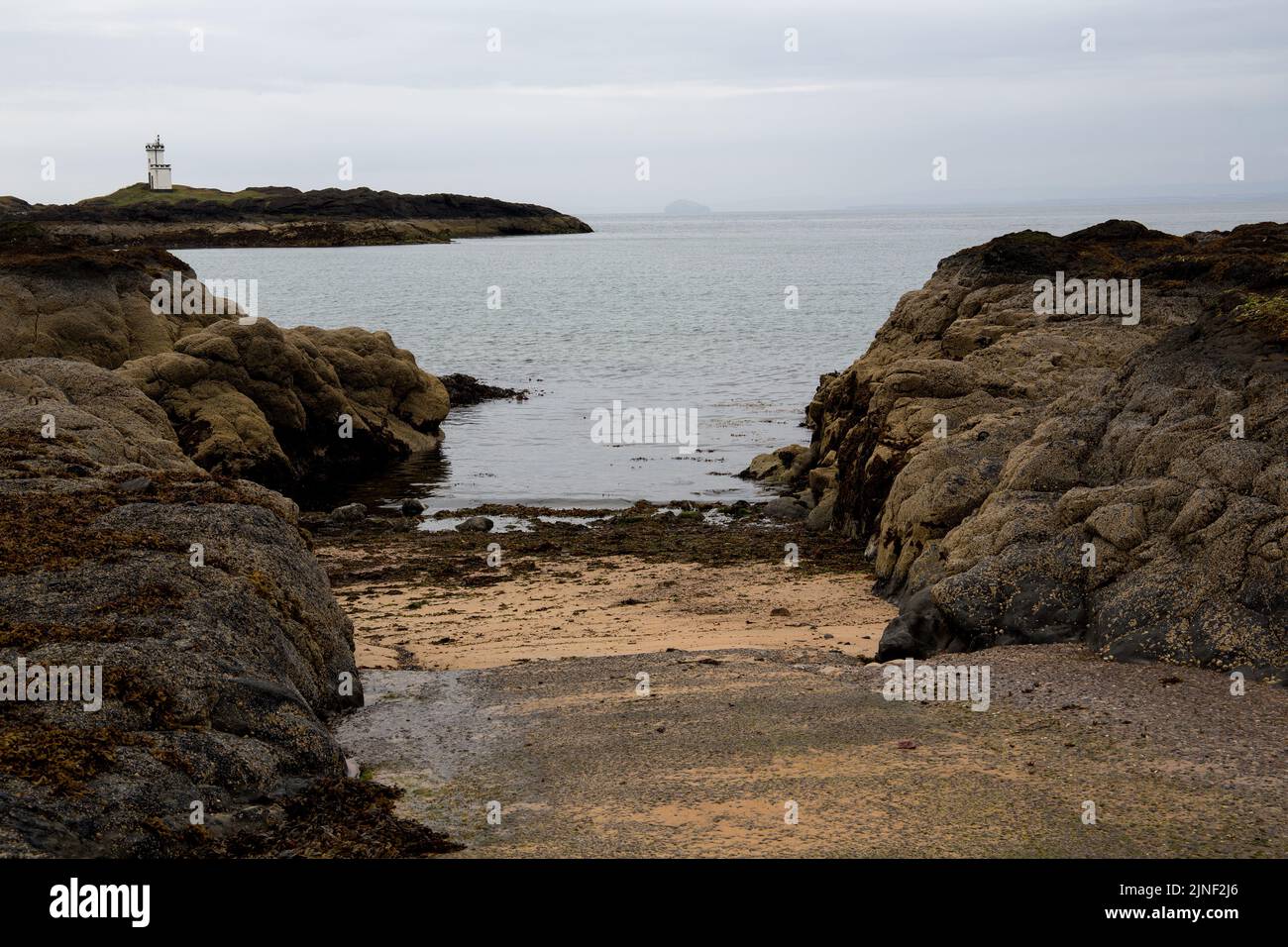 Launching slipway between coastal rocks at a seaside location Stock ...