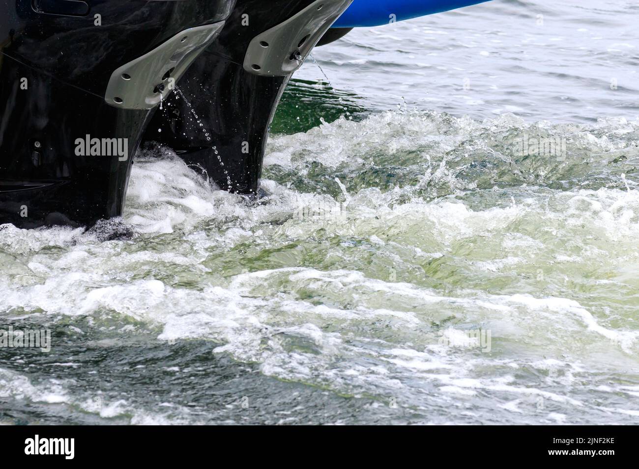 Close up on Water turbulence caused by twin outboard motors propellers ...