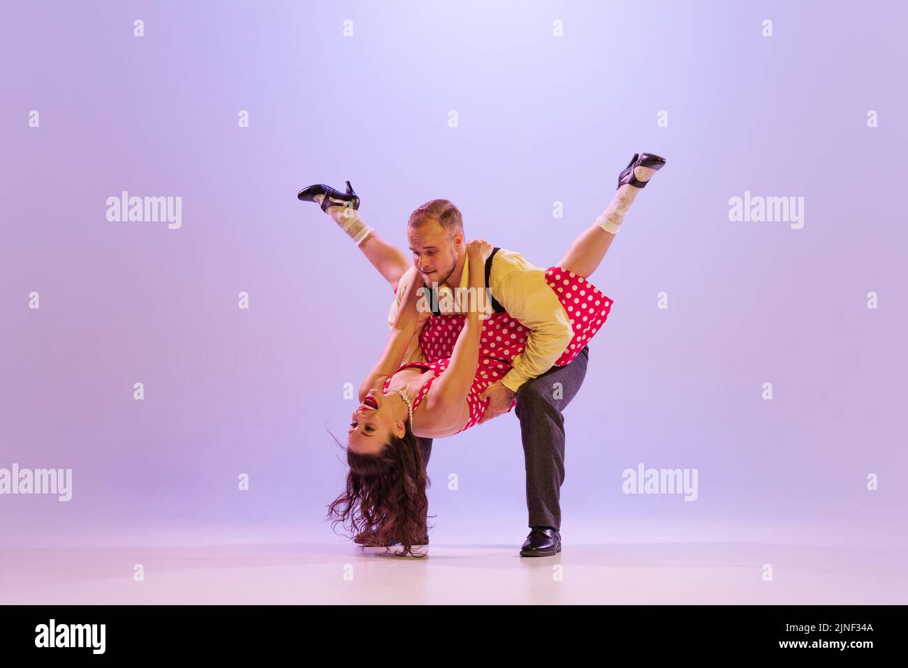 Beautiful girl and man in colorful retro style costumes dancing ...