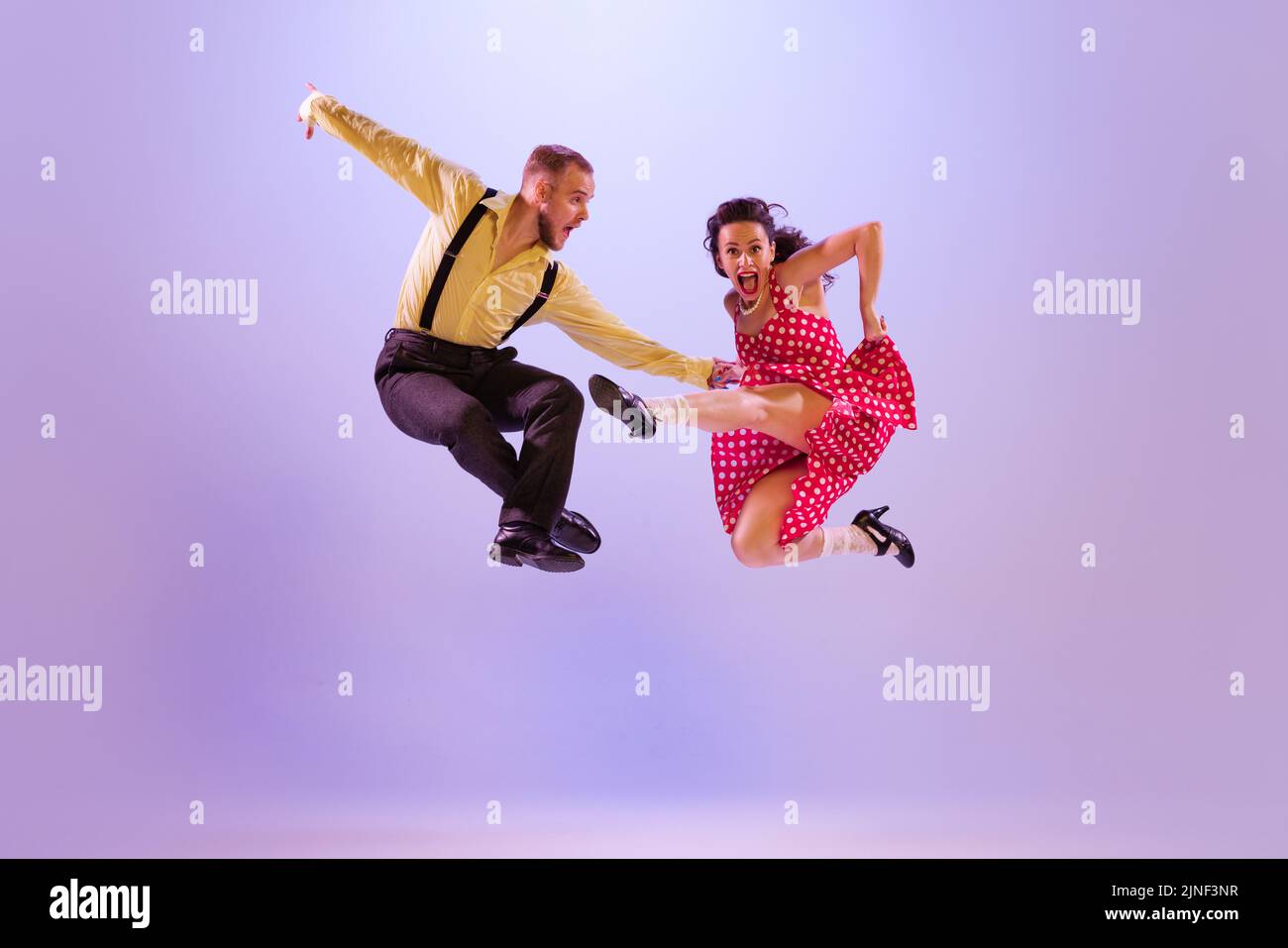 Emotional bright couple of dancers in colorful retro style attires ...
