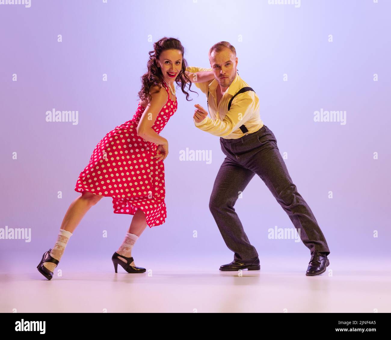 Emotional bright couple of dancers in colorful retro style attires ...