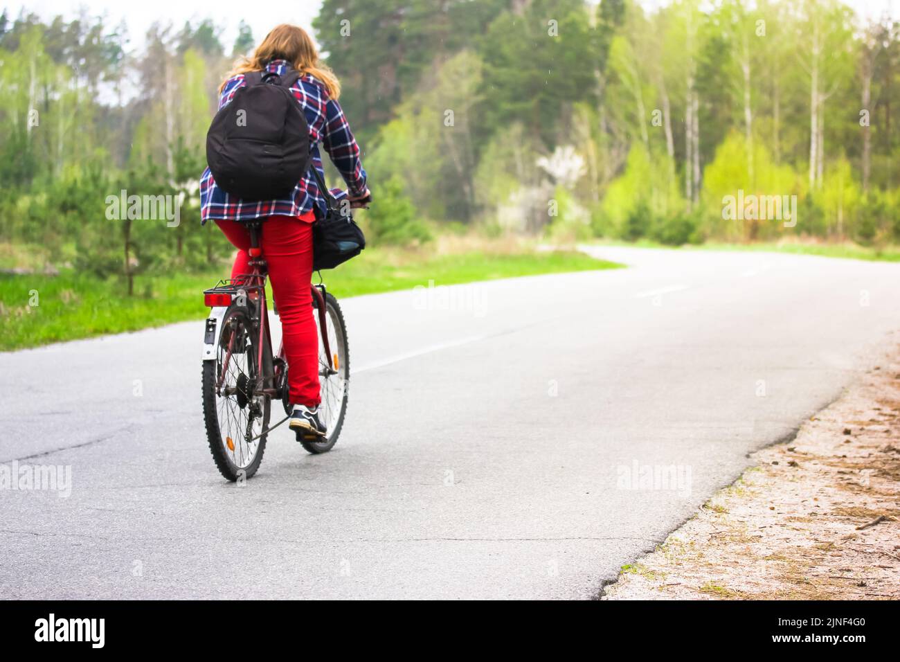 Kiev, Ukraine. May 1, 2020. A girl, young woman in checkered shirt, red ...