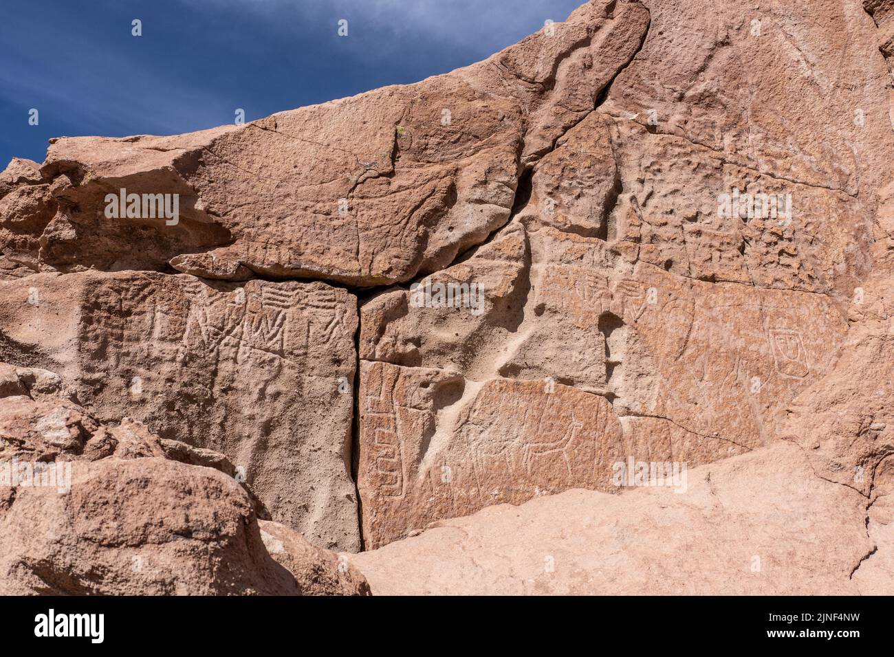 Petroglyphs of seated people and llamas at the Yerbas Buenas Petroglyph ...