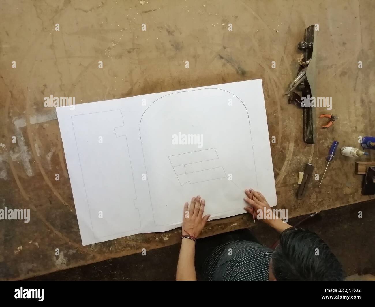 A top view of a carpenter working on a new project at his workshop ...