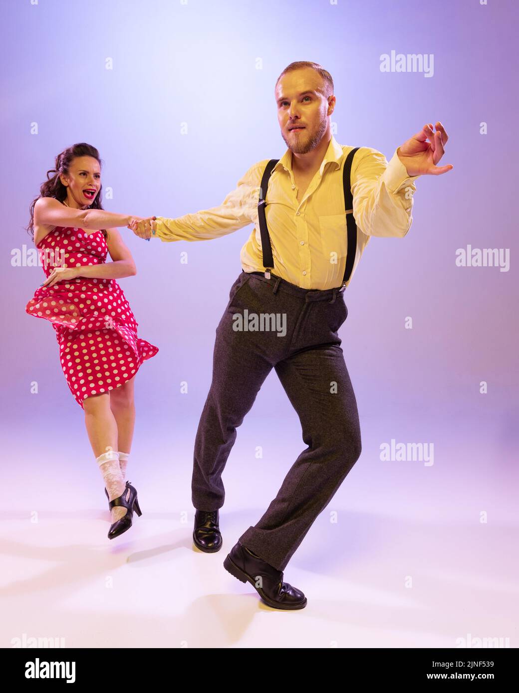Beautiful girl and man in colorful retro style costumes dancing ...