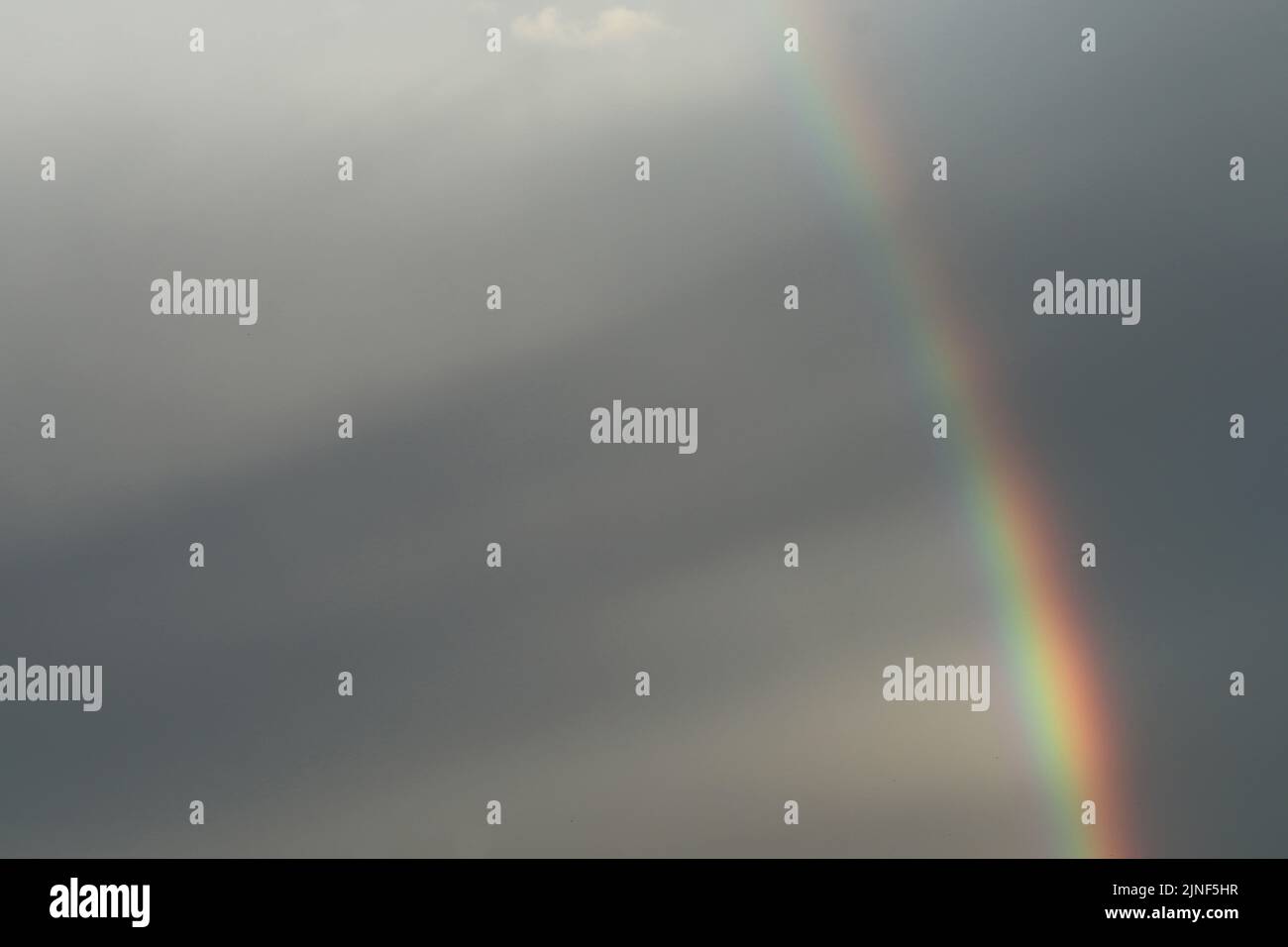 Rainbow in the gray sky Stock Photo - Alamy
