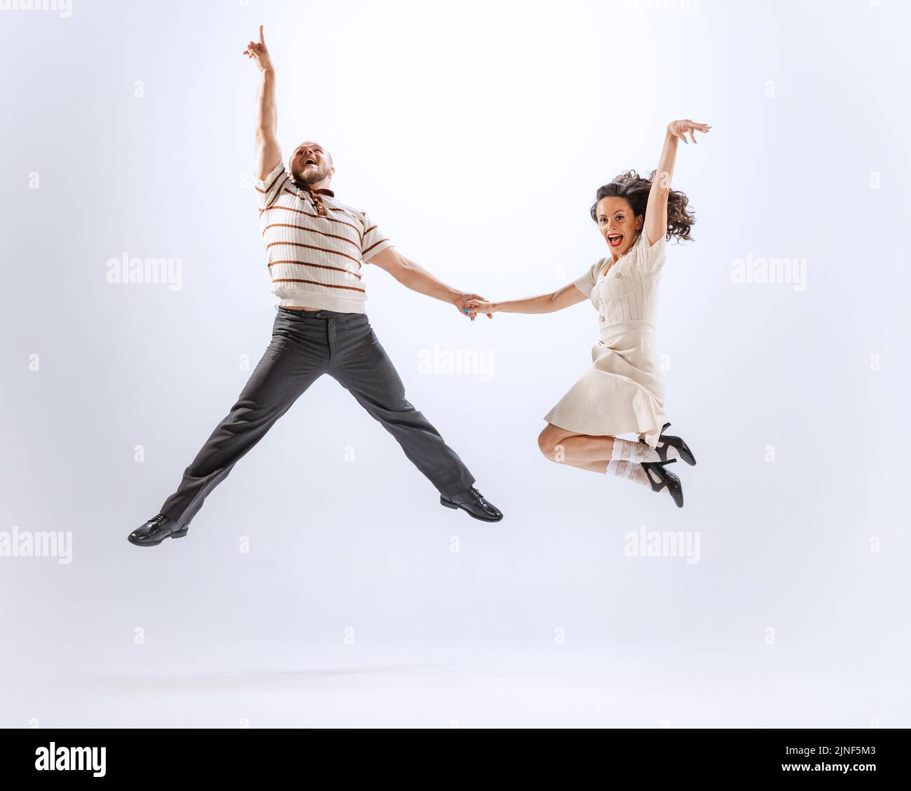 Astonished young dancing man and woman dance sport dances isolated on ...