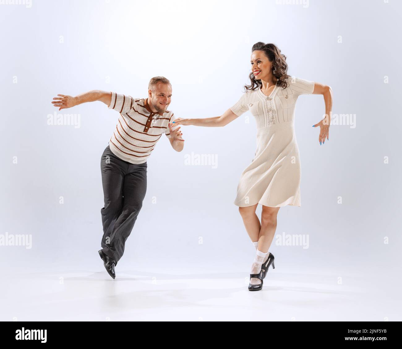 Astonished young dancing man and woman dance sport dances isolated on ...