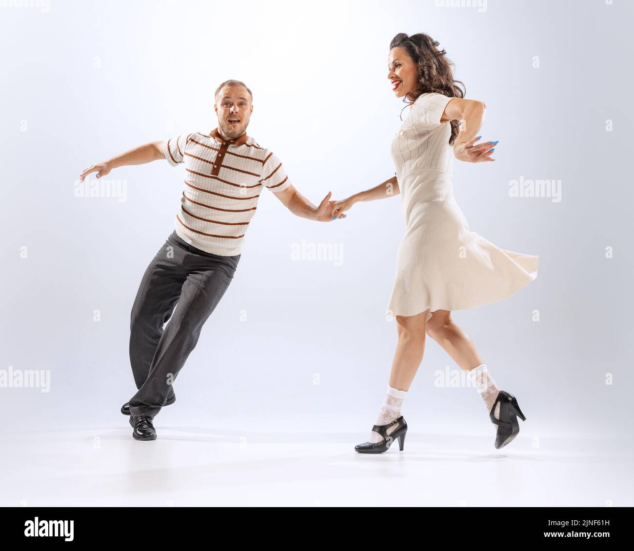 Astonished young dancing man and woman dance sport dances isolated on ...