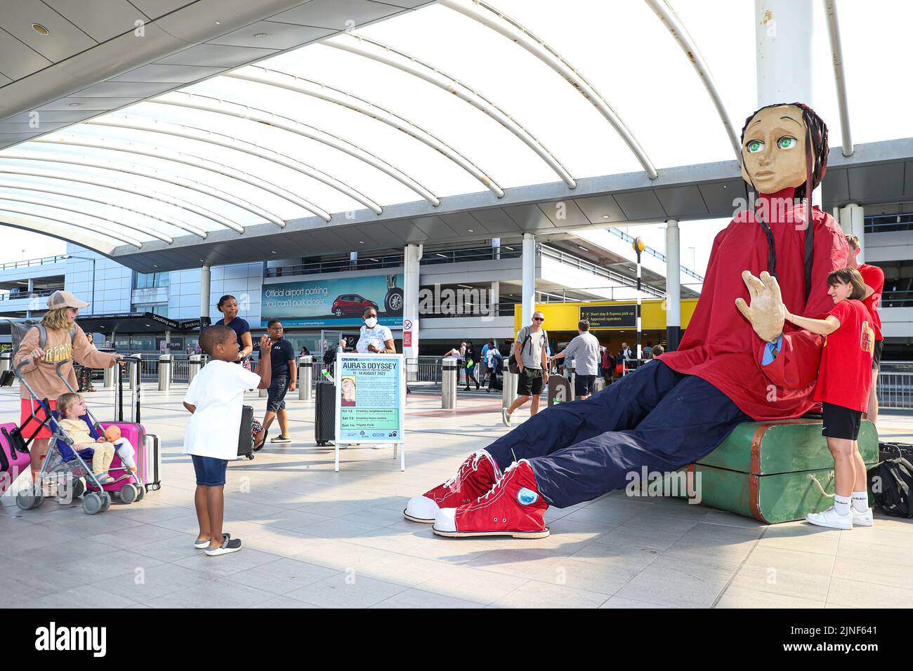 EDITORIAL USE ONLY Members of the public greet Aura, a five-metre tall ...