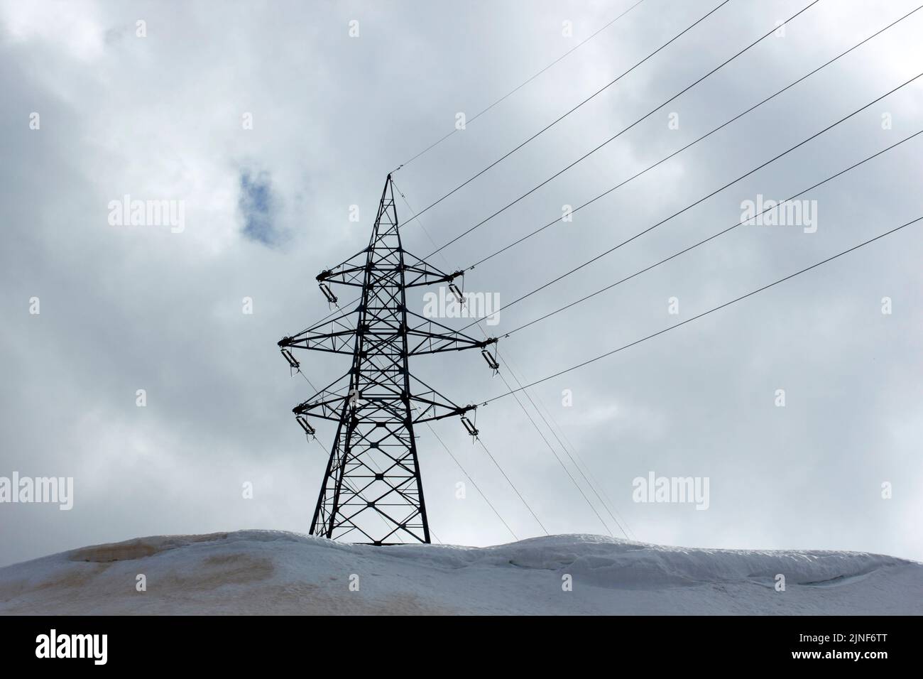 High voltage electricity pylon under snow landscape Stock Photo - Alamy