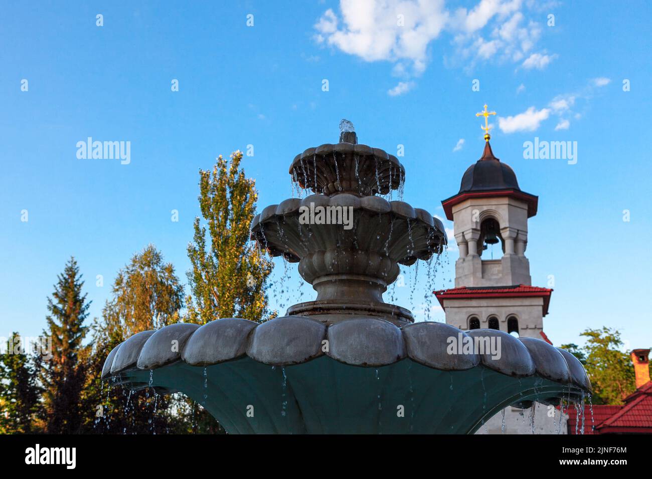 Marble fountain and church steeple . Splashing fountain water Stock ...