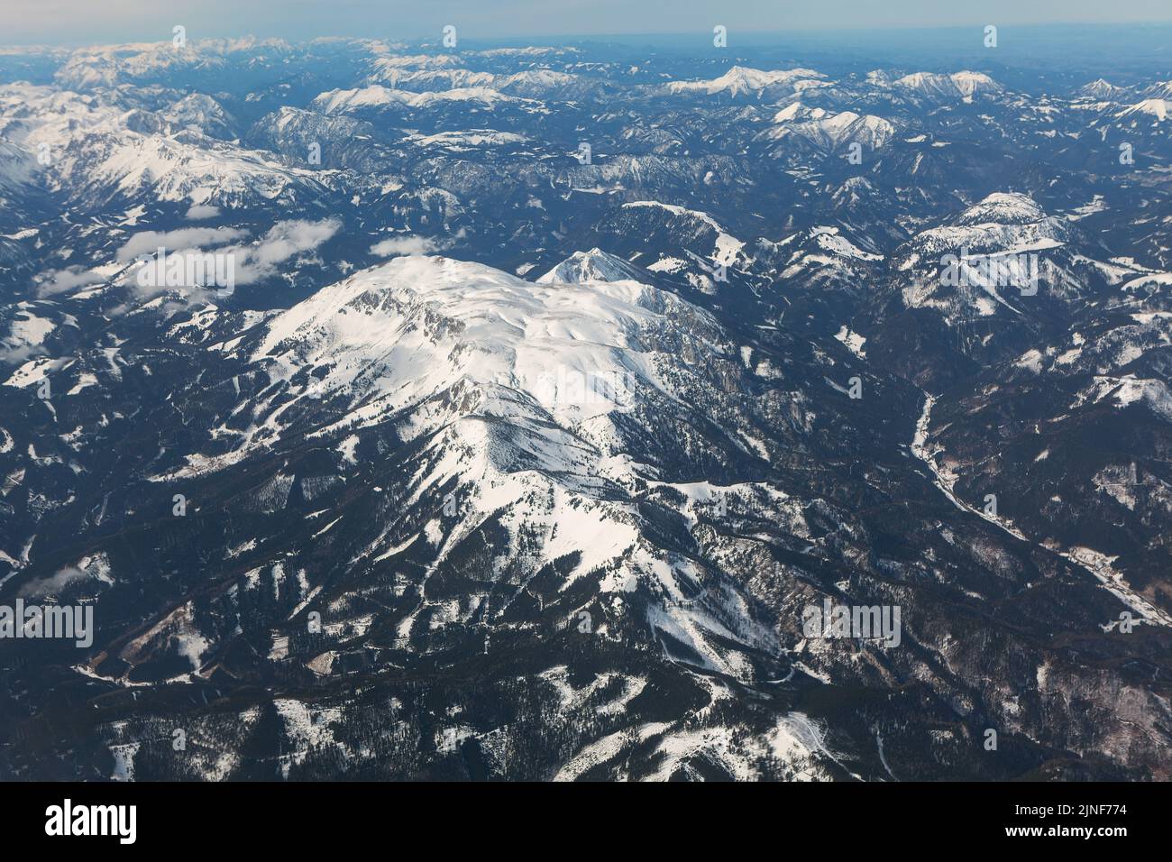 Black mountains covered by snow . Aerial view of snowy mountain peaks ...